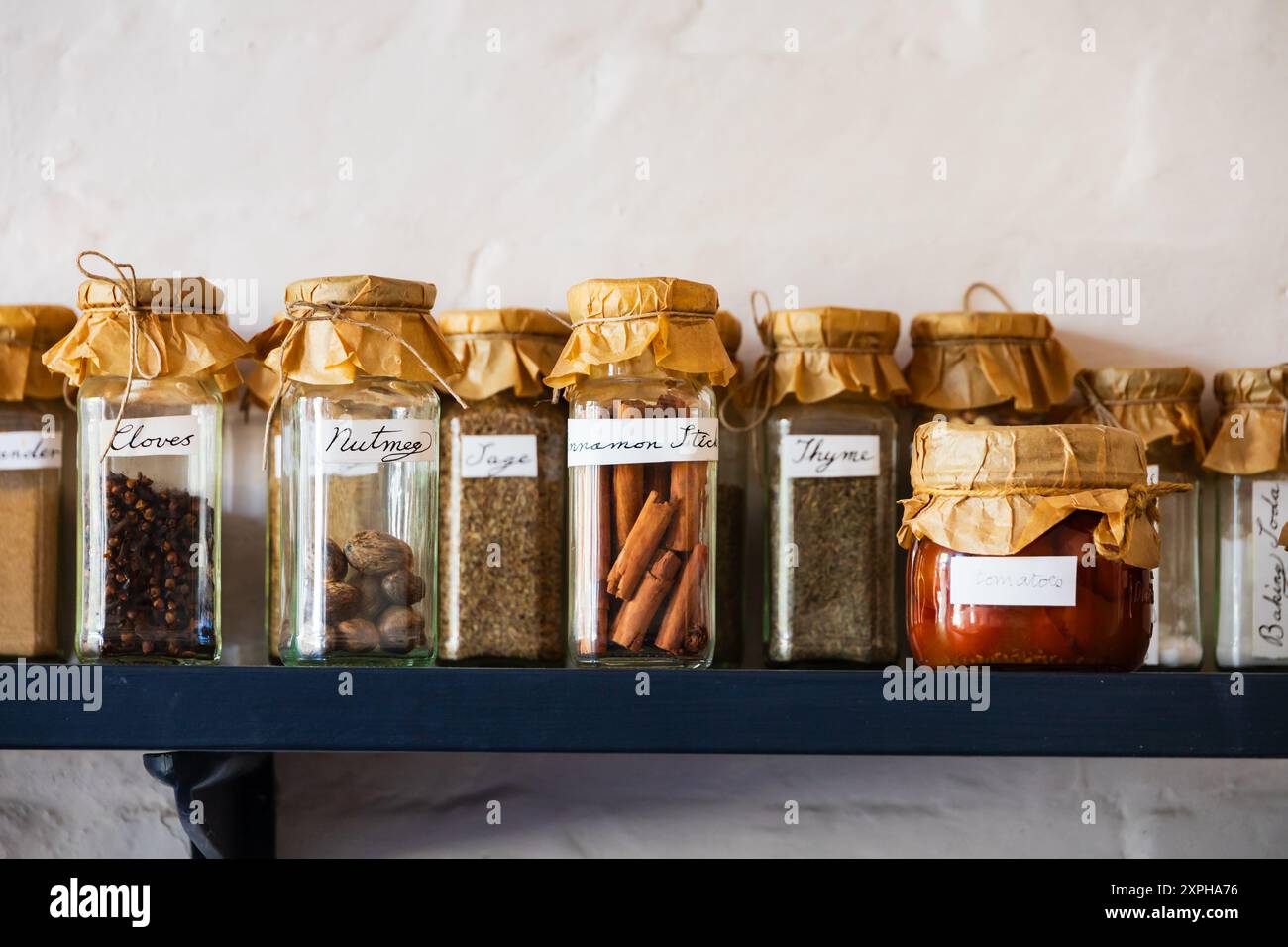 Old glass spice storage jars with greaseproof paper tied with string on ...