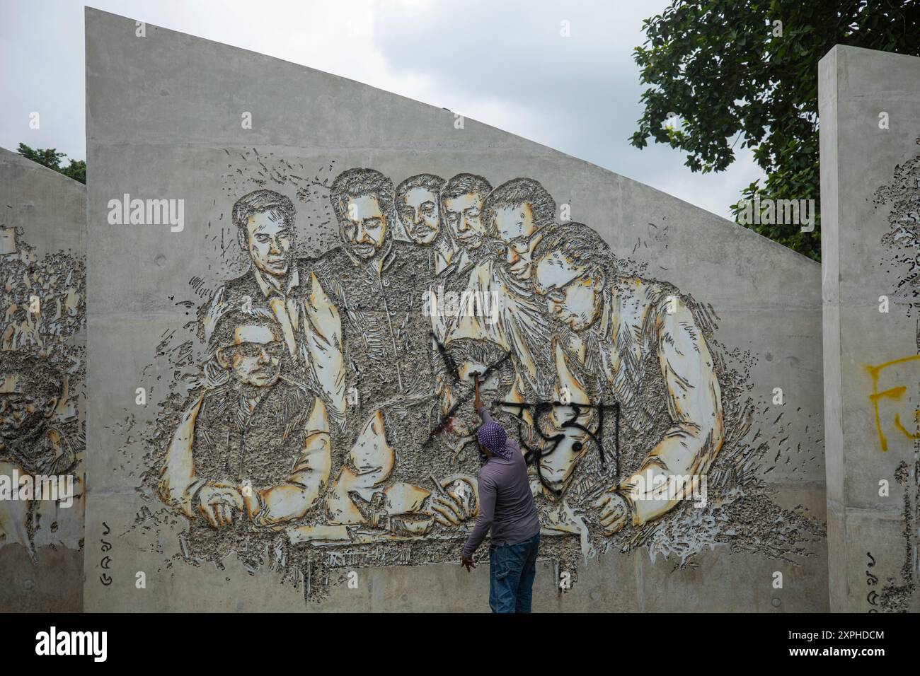 A man vandalises a mural of Sheikh Mujibur Rahman, father of Sheikh ...