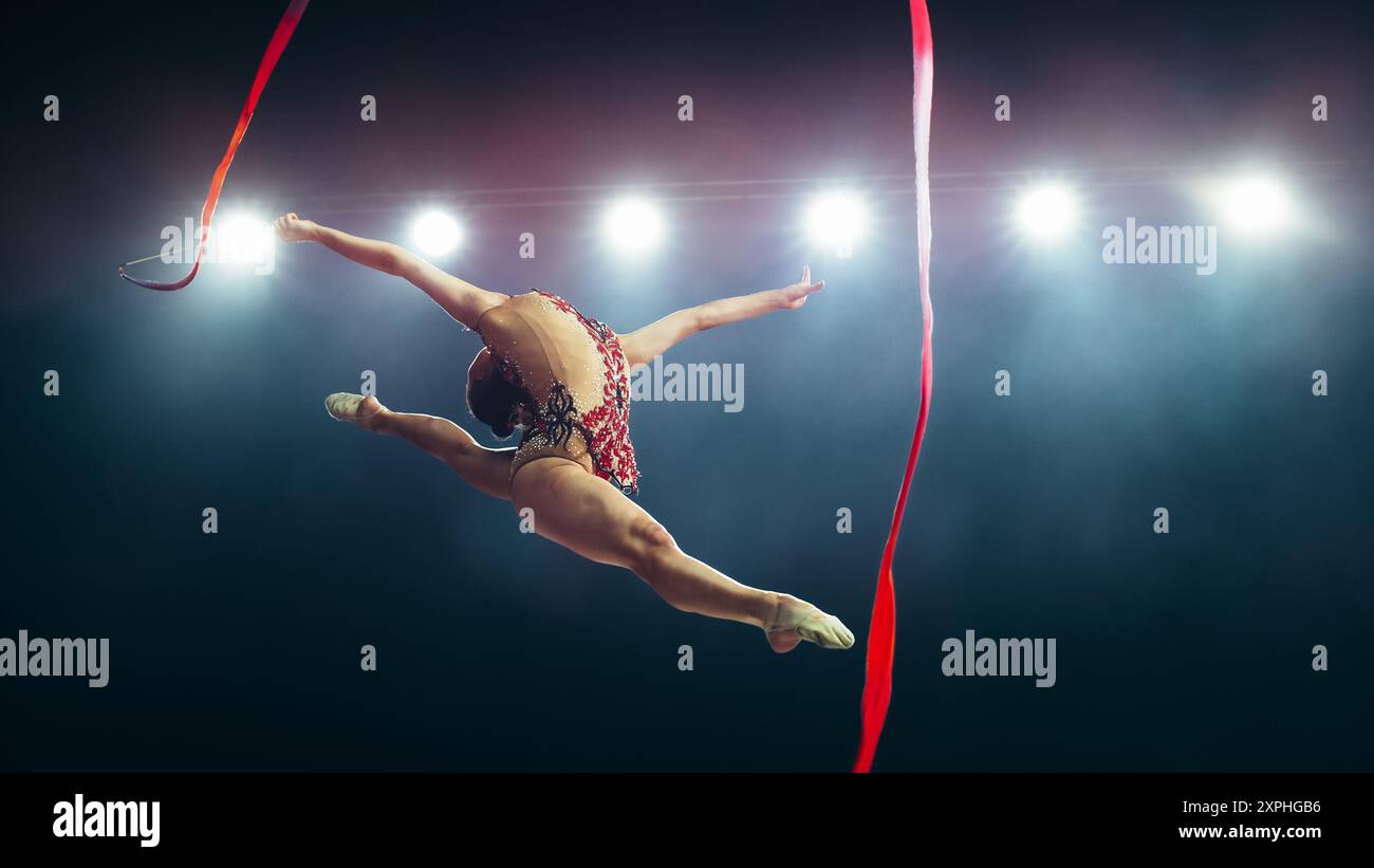 Female Gymnast in Mid-air, Executing Flawless Split Leap With Ribbon ...