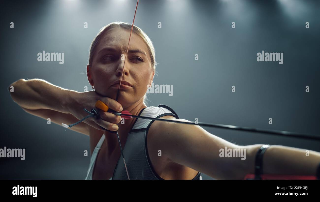 Close-Up Portrait Of Professional Female Archer in Action. Portrait of ...