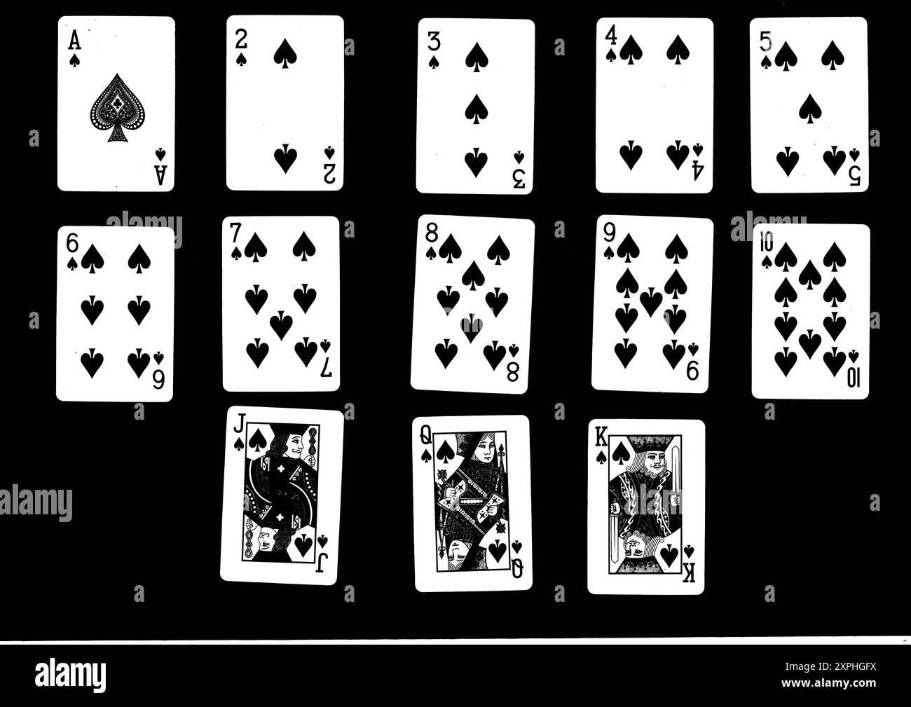A full suit of spades playing cards in black on a black background ...