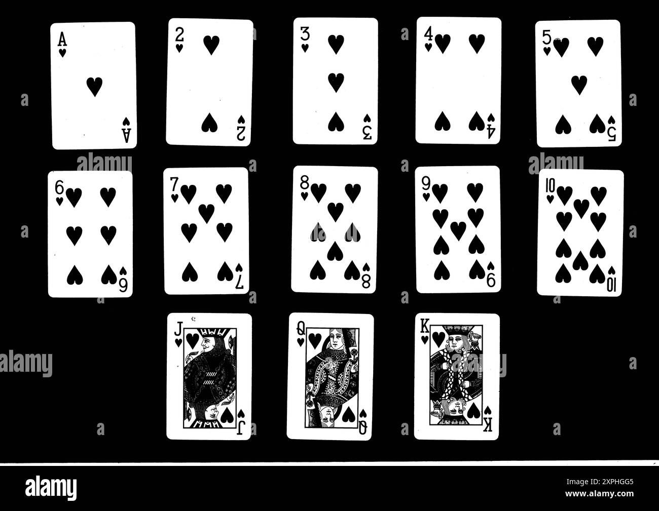 A full suit of hearts playing cards in black on a black background ...