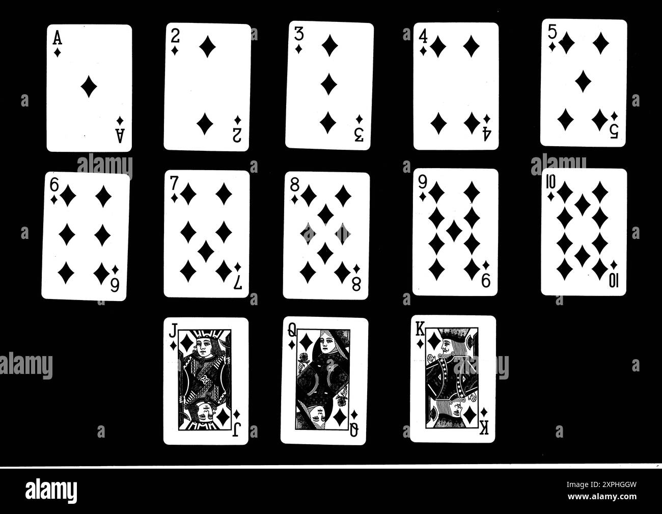 A full suit of diamonds playing cards in black on a black background ...