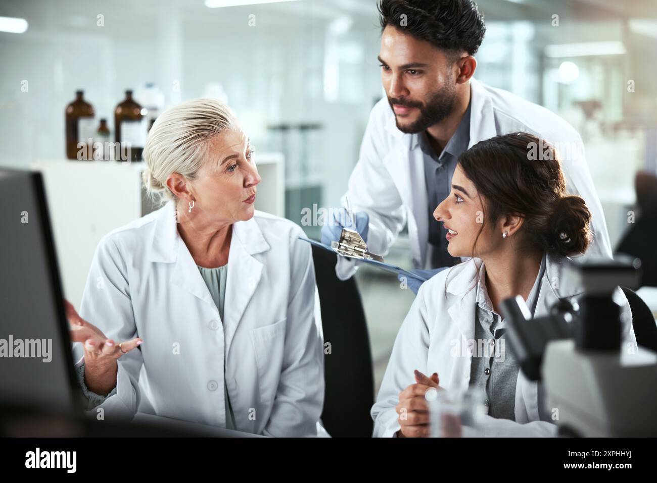 Computer, discussion and manager with scientists in lab for ...