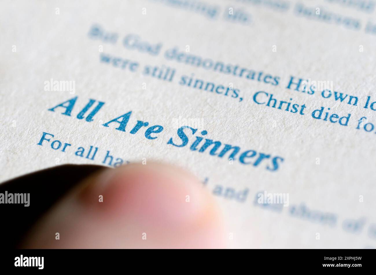 Finger pointing a religious sentence in the New Testament book Stock ...