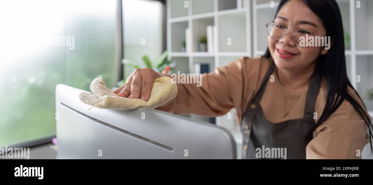 Professional Housekeeper Cleaning a Modern Home Office with a Smile ...