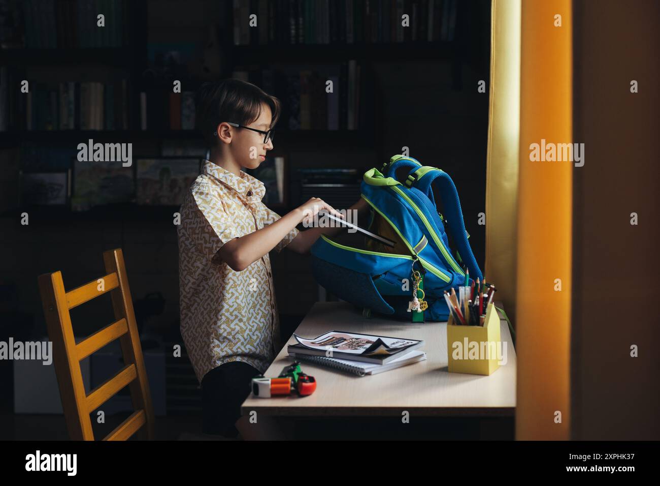 Student preparing for school standing in kids room and collecting stuff ...