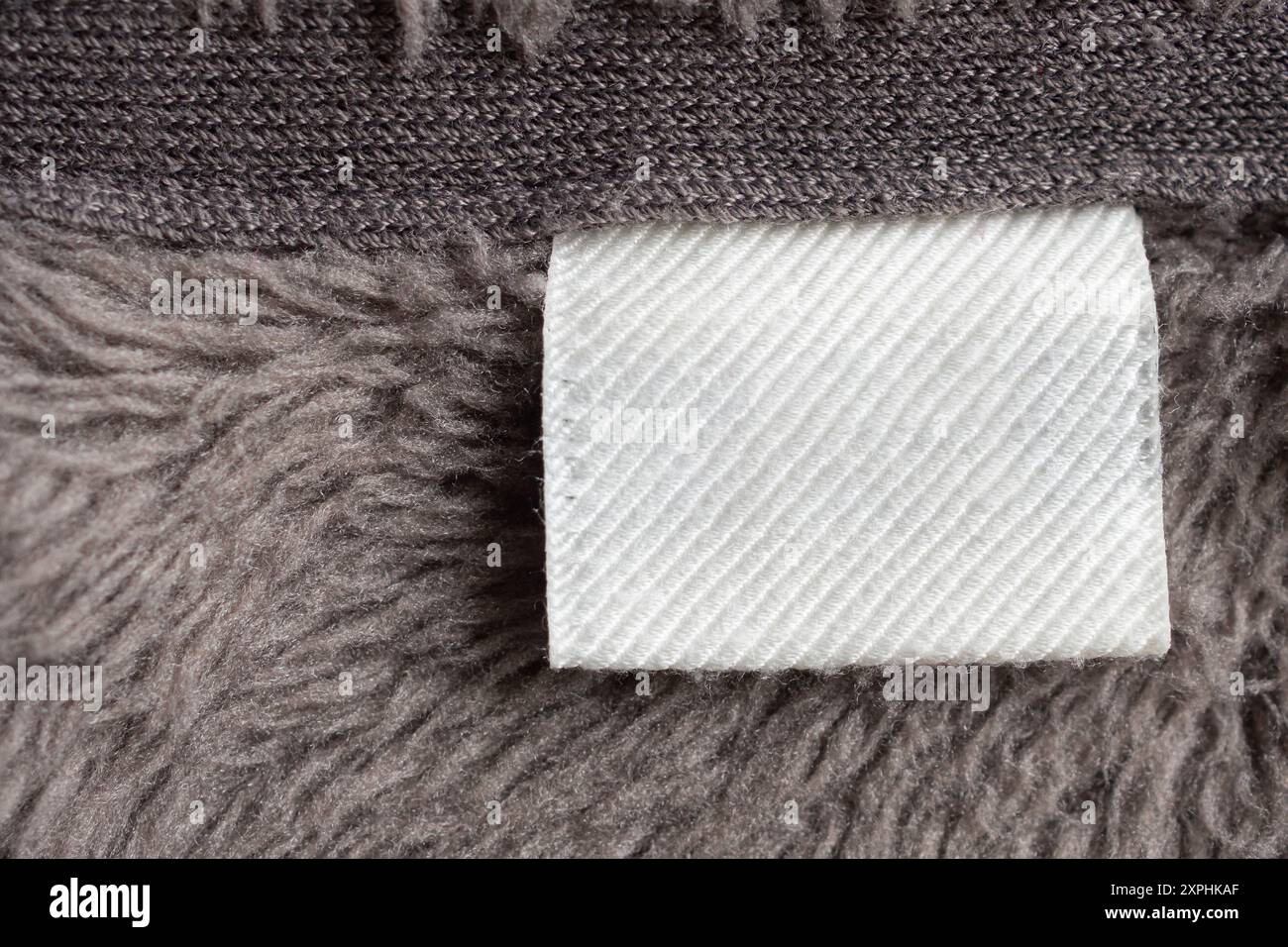 Blank white laundry care clothing label on fur texture background Stock ...