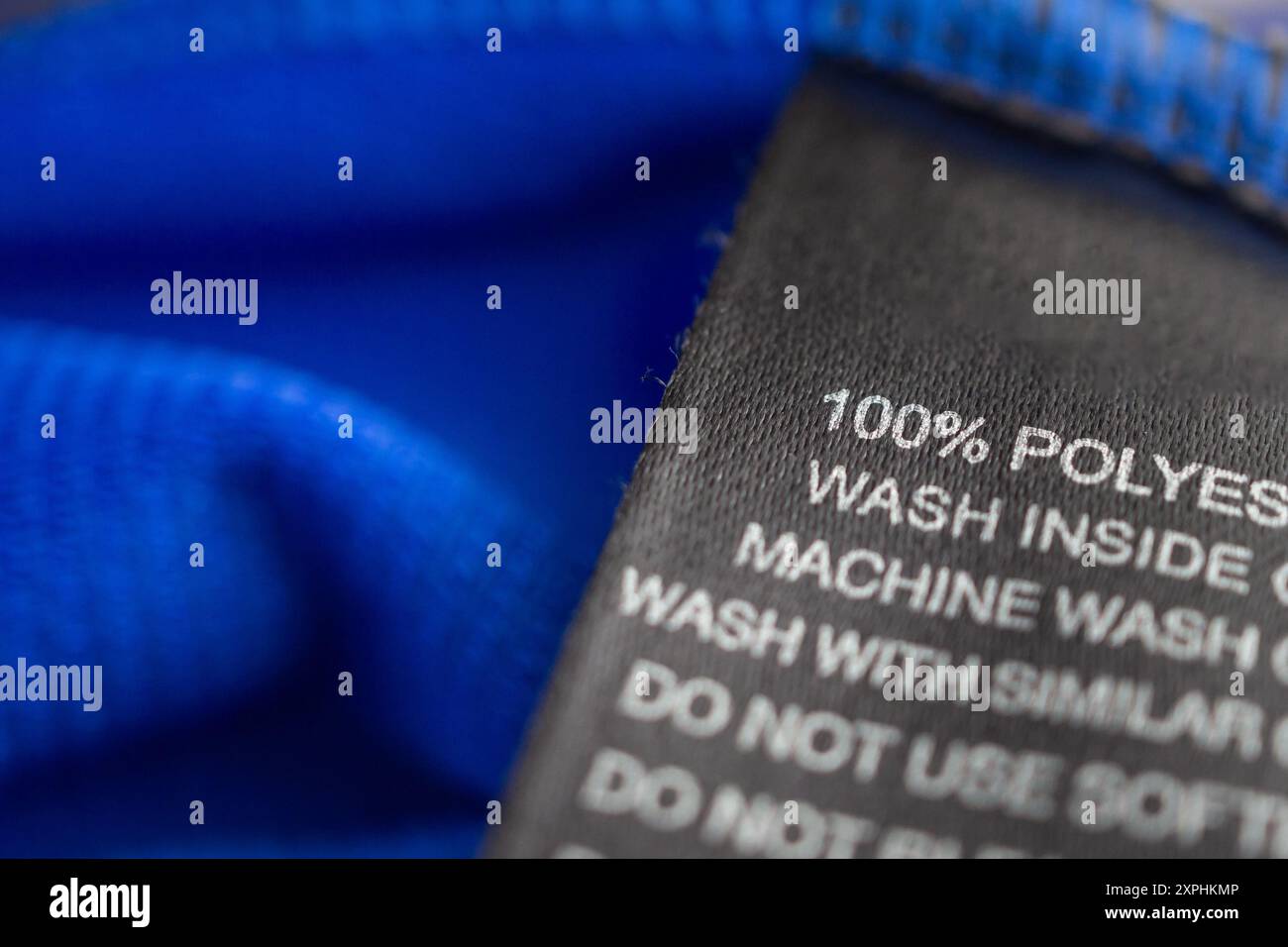 Black laundry care washing instructions clothes label on blue jersey ...