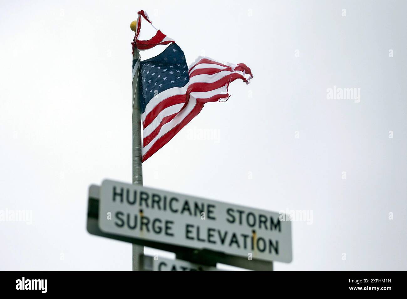 An American flag is nearly shredded from the winds from Tropical Storm ...