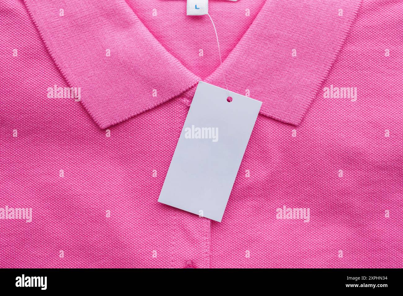 Blank white clothes tag label on new shirt Stock Photo - Alamy