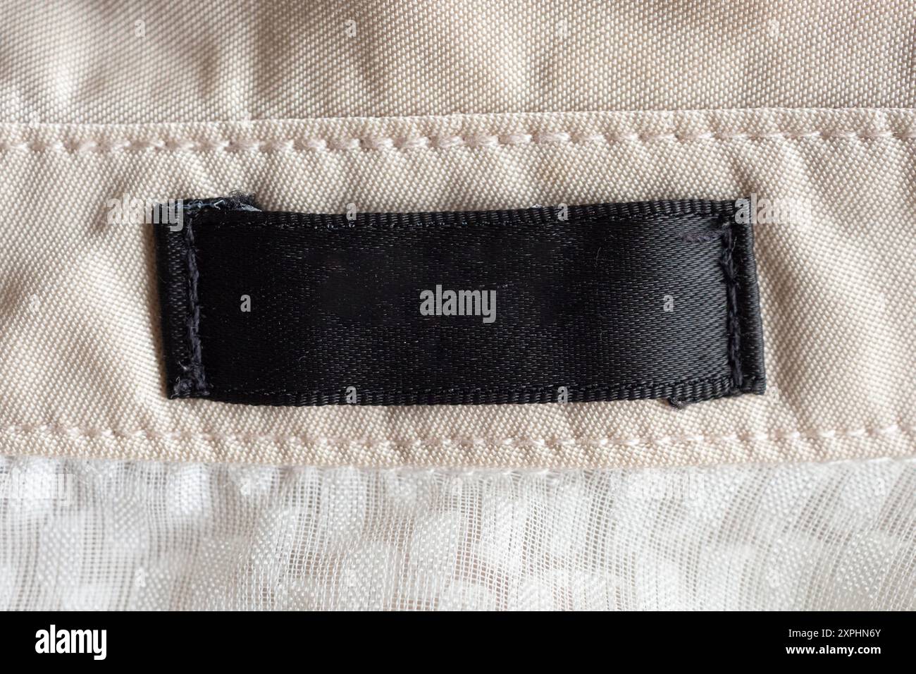 Blank black laundry care clothing label on fabric texture Stock Photo ...