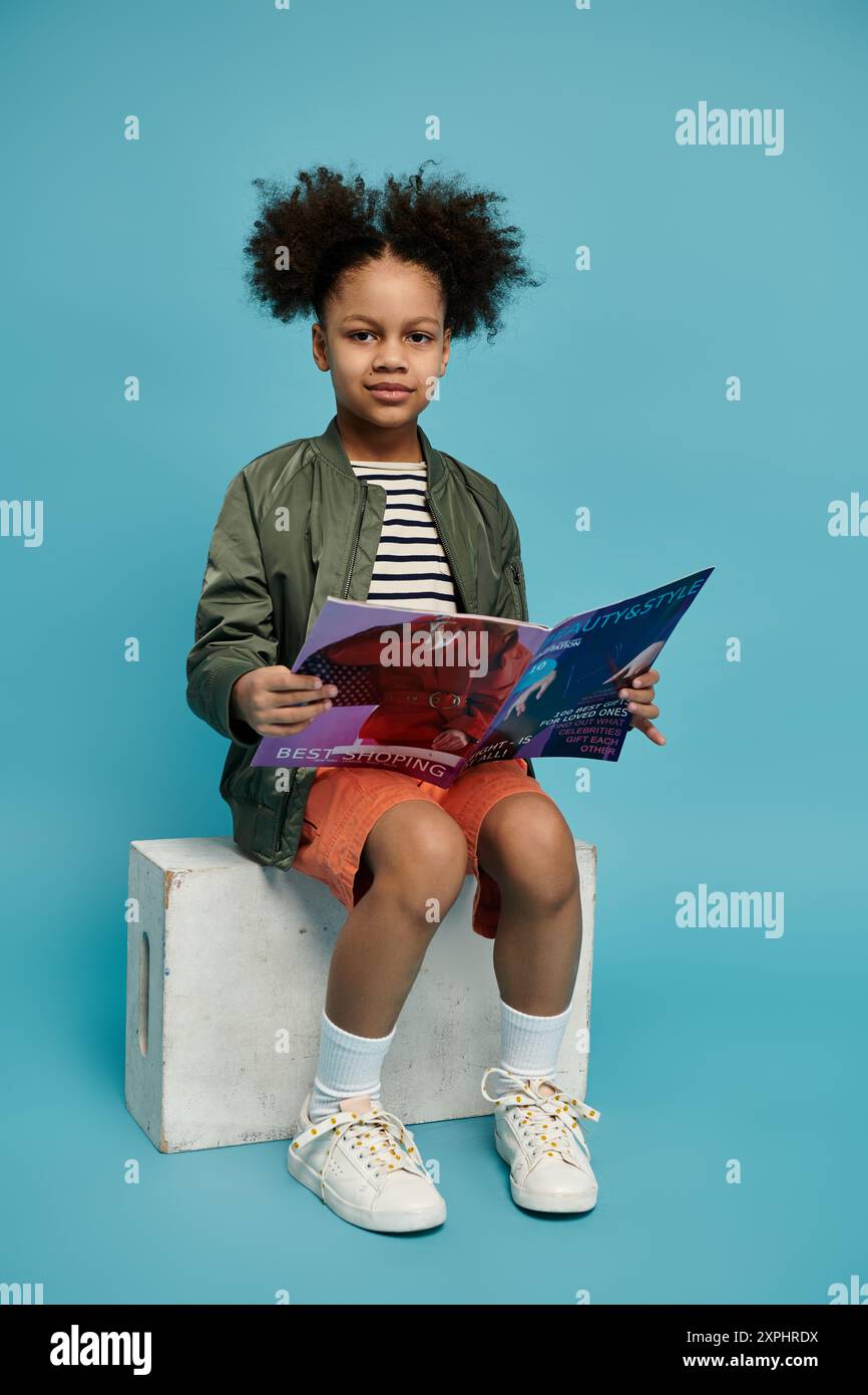 Black child reading a magazine hi-res stock photography and images - Alamy