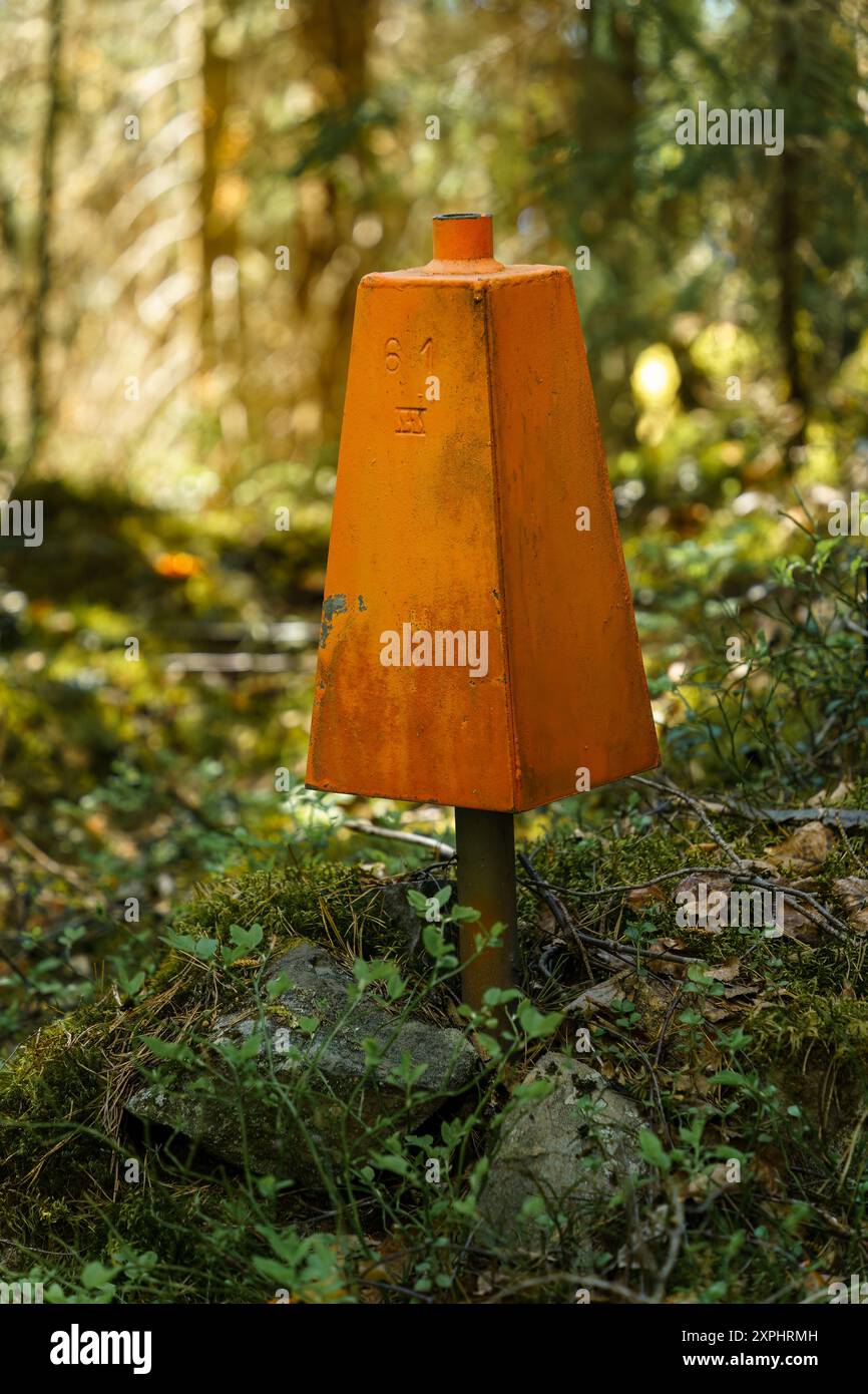 Red metallic boundary marker in a Finnish Forest Stock Photo - Alamy