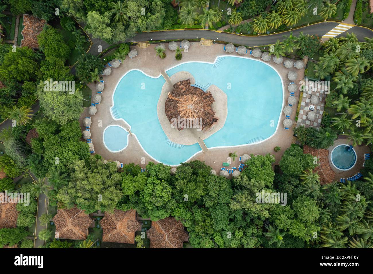 Blue big swimming pool with bar in middle aerial drone top view Stock ...