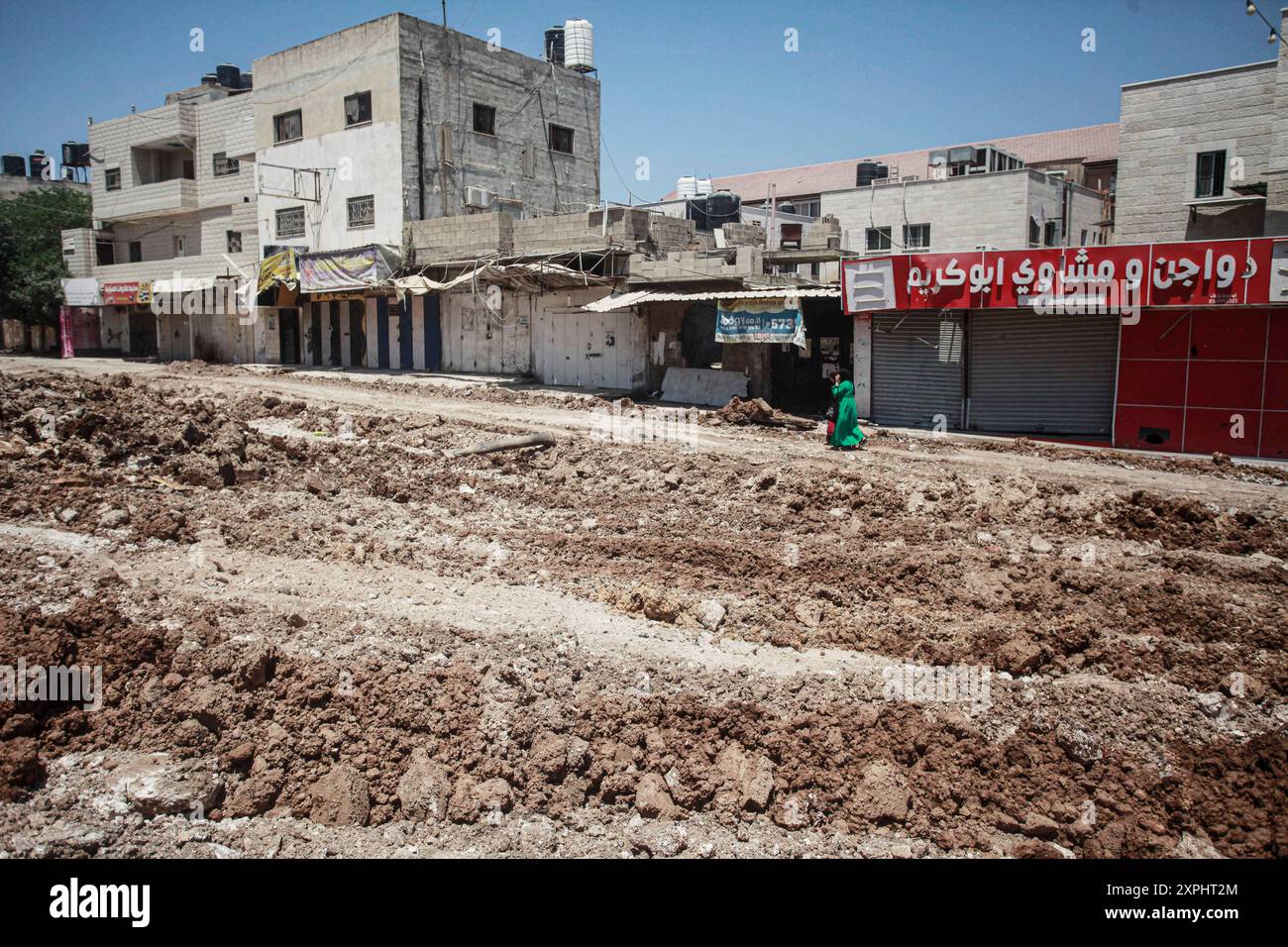 Palestinians inspect the destruction following an Israeli raid in Jenin ...