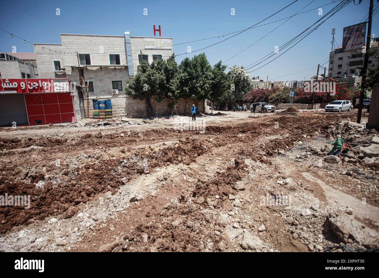 Palestinians inspect the destruction following an Israeli raid in Jenin ...