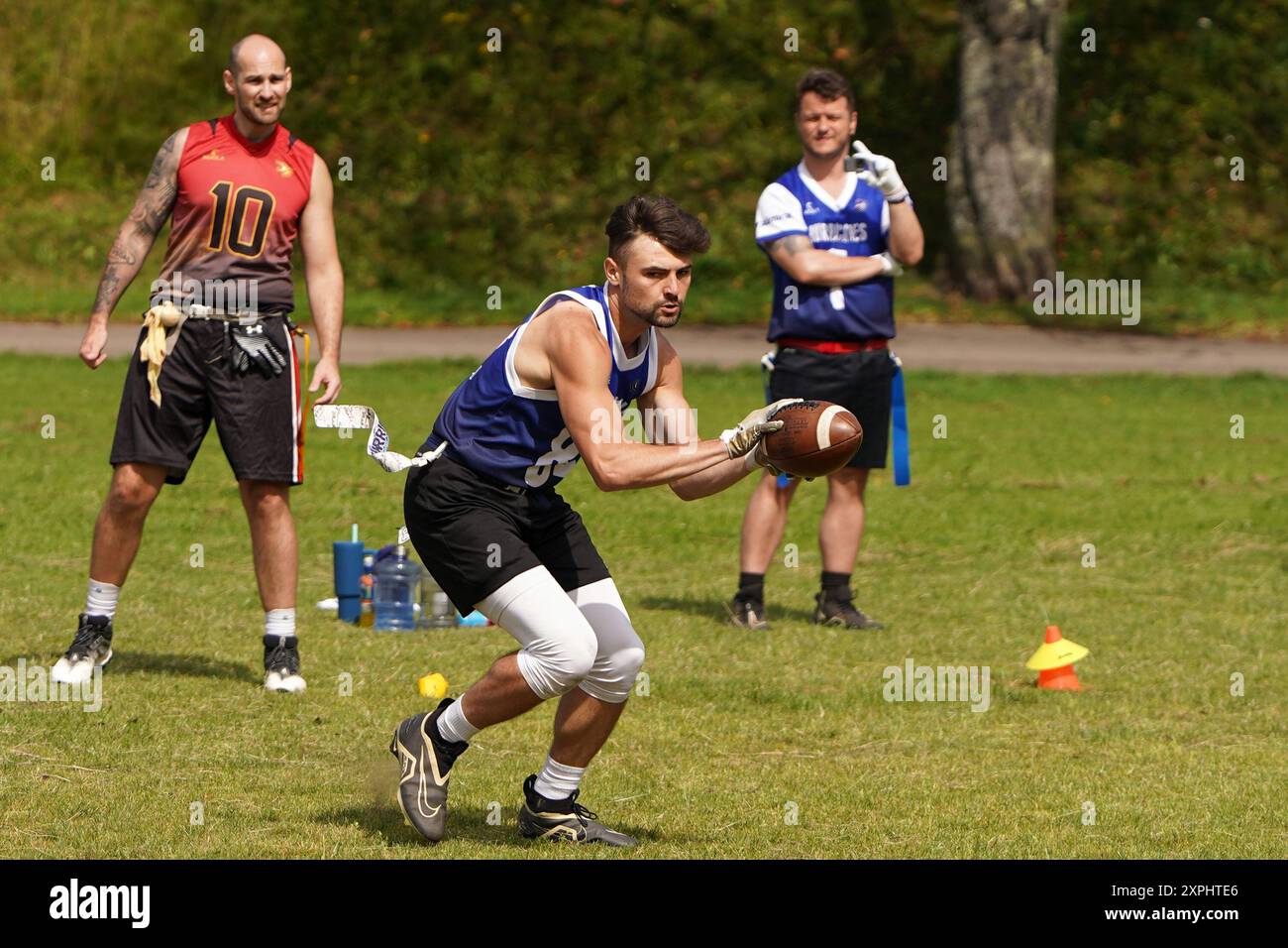 A male flag football player catches the ball Stock Photo - Alamy