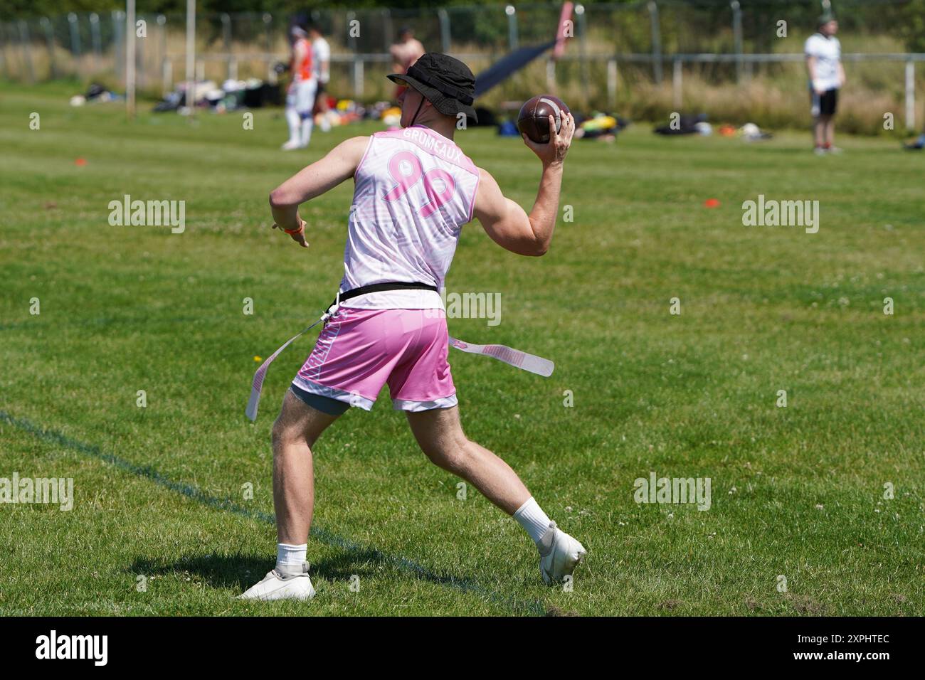A male flag football quarterback throws the ball Stock Photo - Alamy