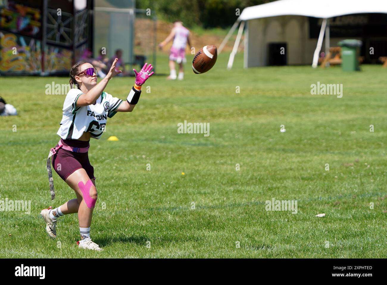 A female flag football quarterback receives the snap Stock Photo - Alamy