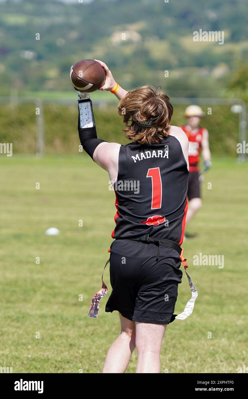 Male flag football quarterback receives the ball from the snap Stock ...