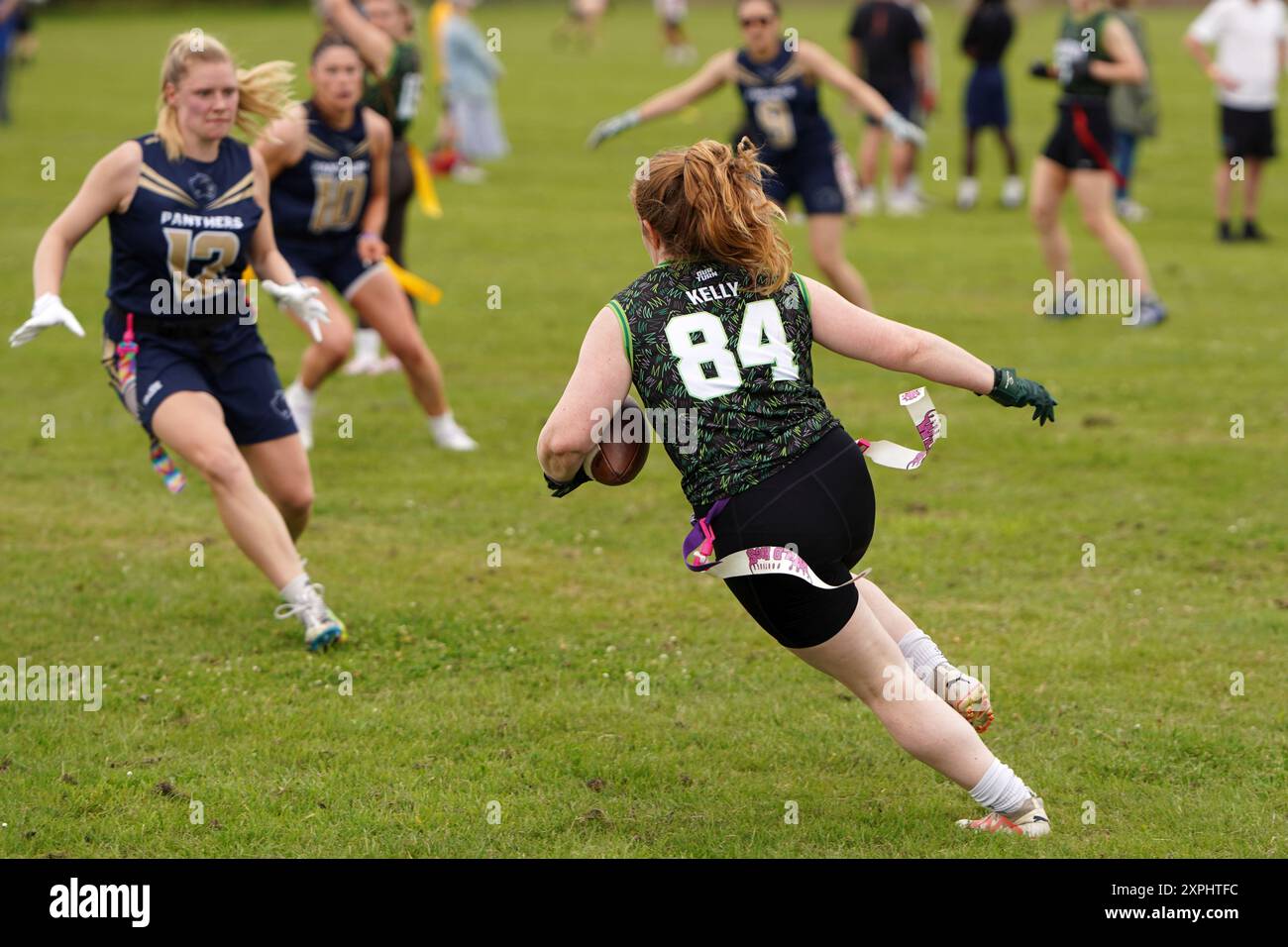 An attacker tries to beat her defender in a women's flag football game ...