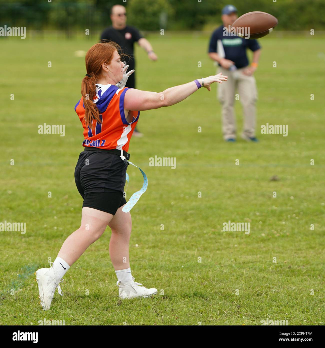 A female flag football quarterback throws the ball Stock Photo - Alamy
