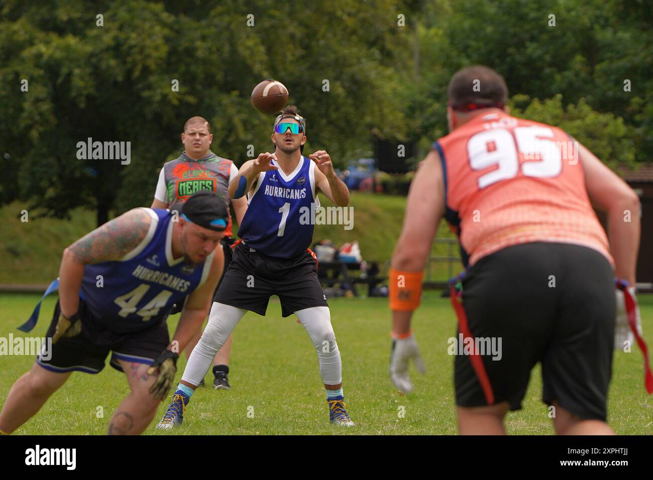 A male flag football quarterback receives the snap Stock Photo - Alamy