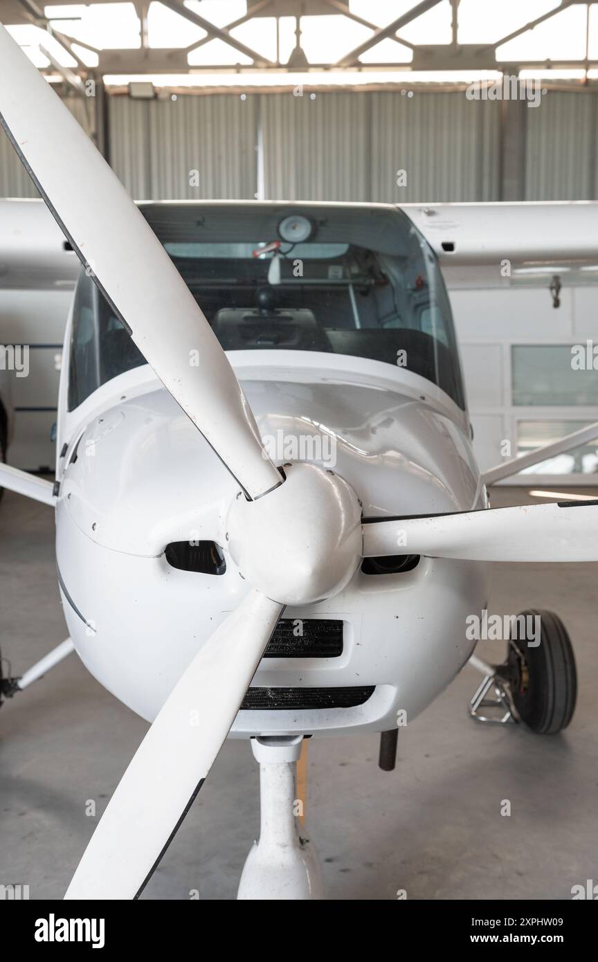 Small private lightweight propeller airplane in hangar, closeup photo ...