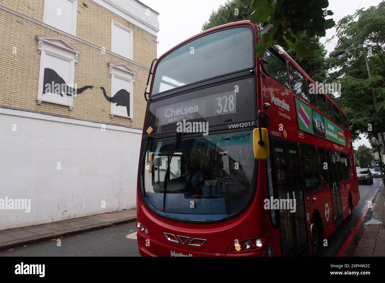 London, UK. 06 Aug 2024. A bus drives past a new mural by Street Artist ...