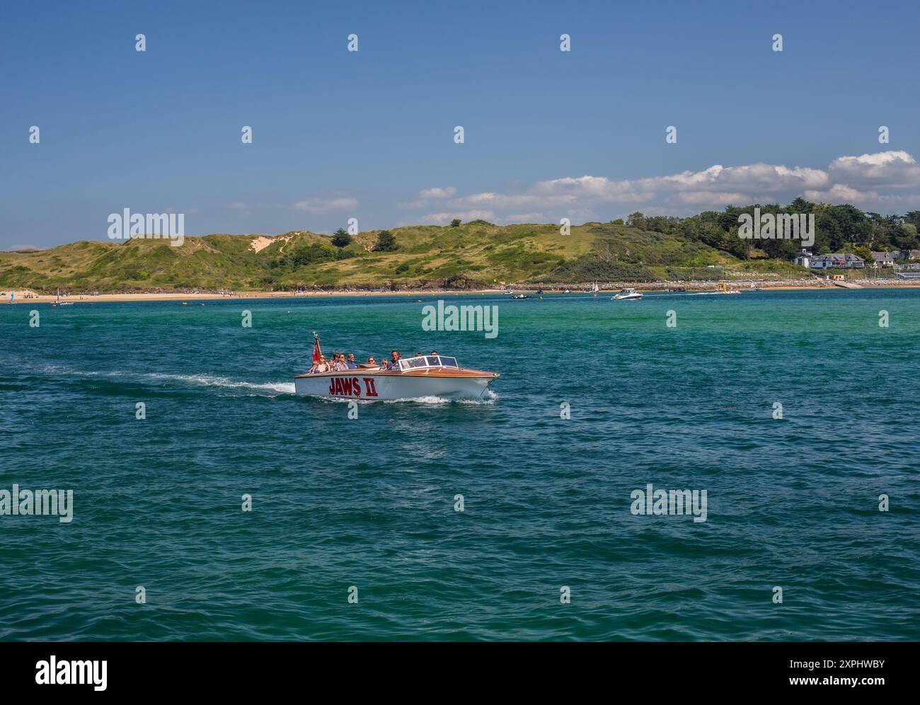 A beautiful motor speedboat takes passengers on a trip around Rock and ...
