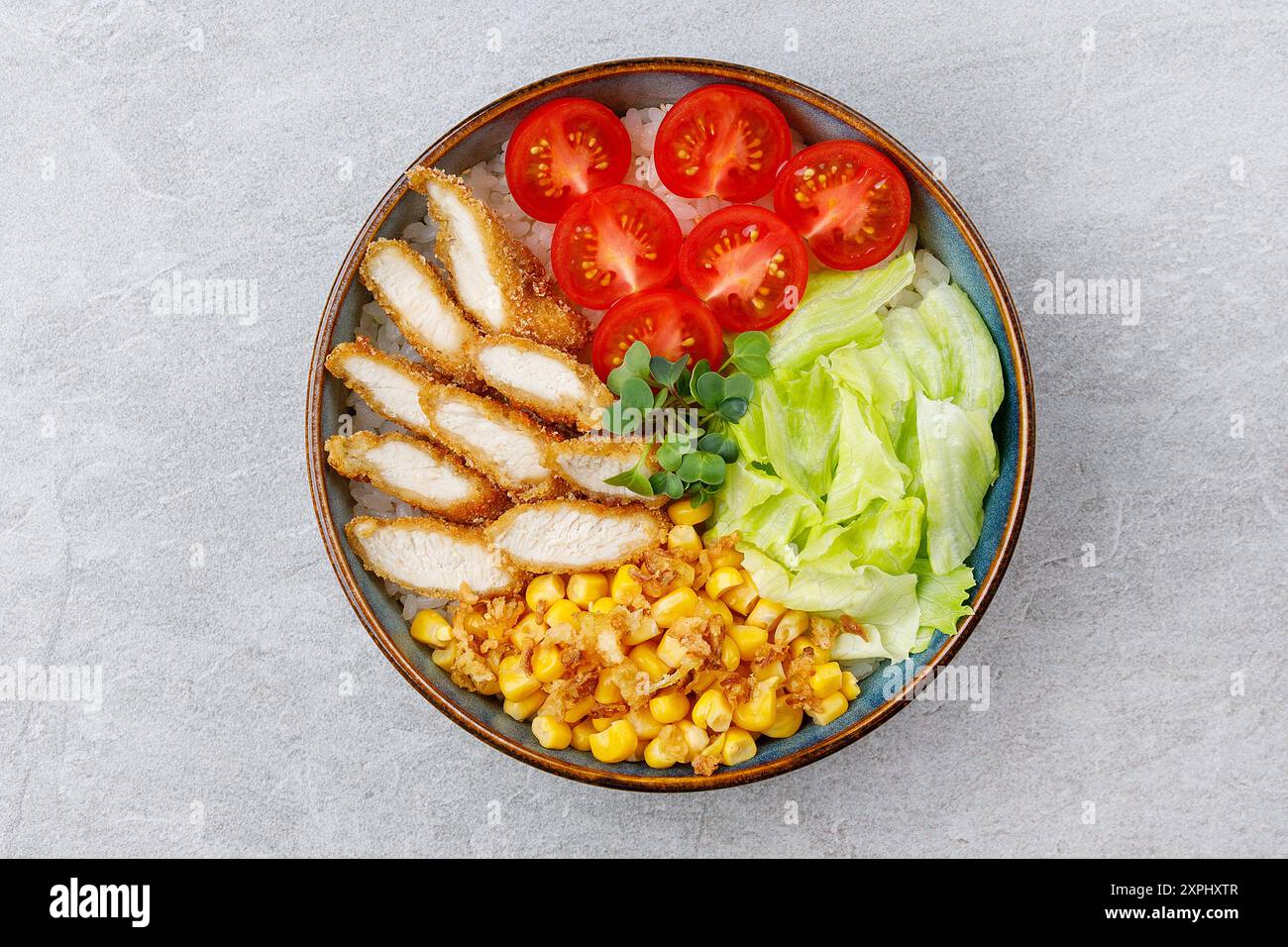 Crispy breaded chicken poke bowl on a gray background for a food ...