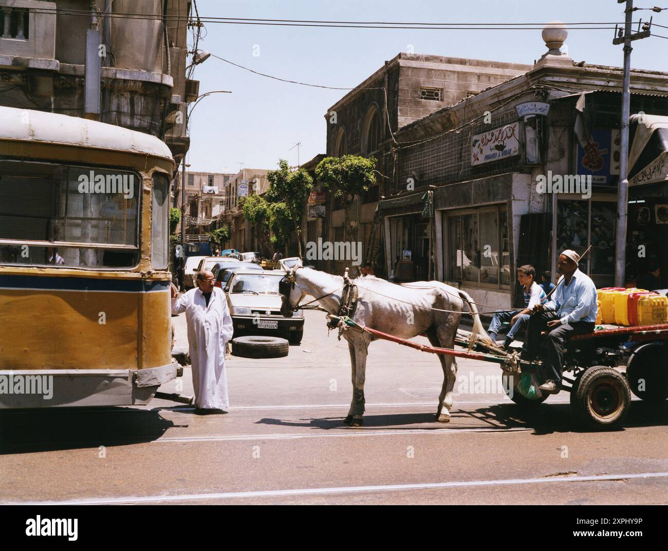 A bustling street in Alexandria, 2006, featuring a vintage bus and a ...
