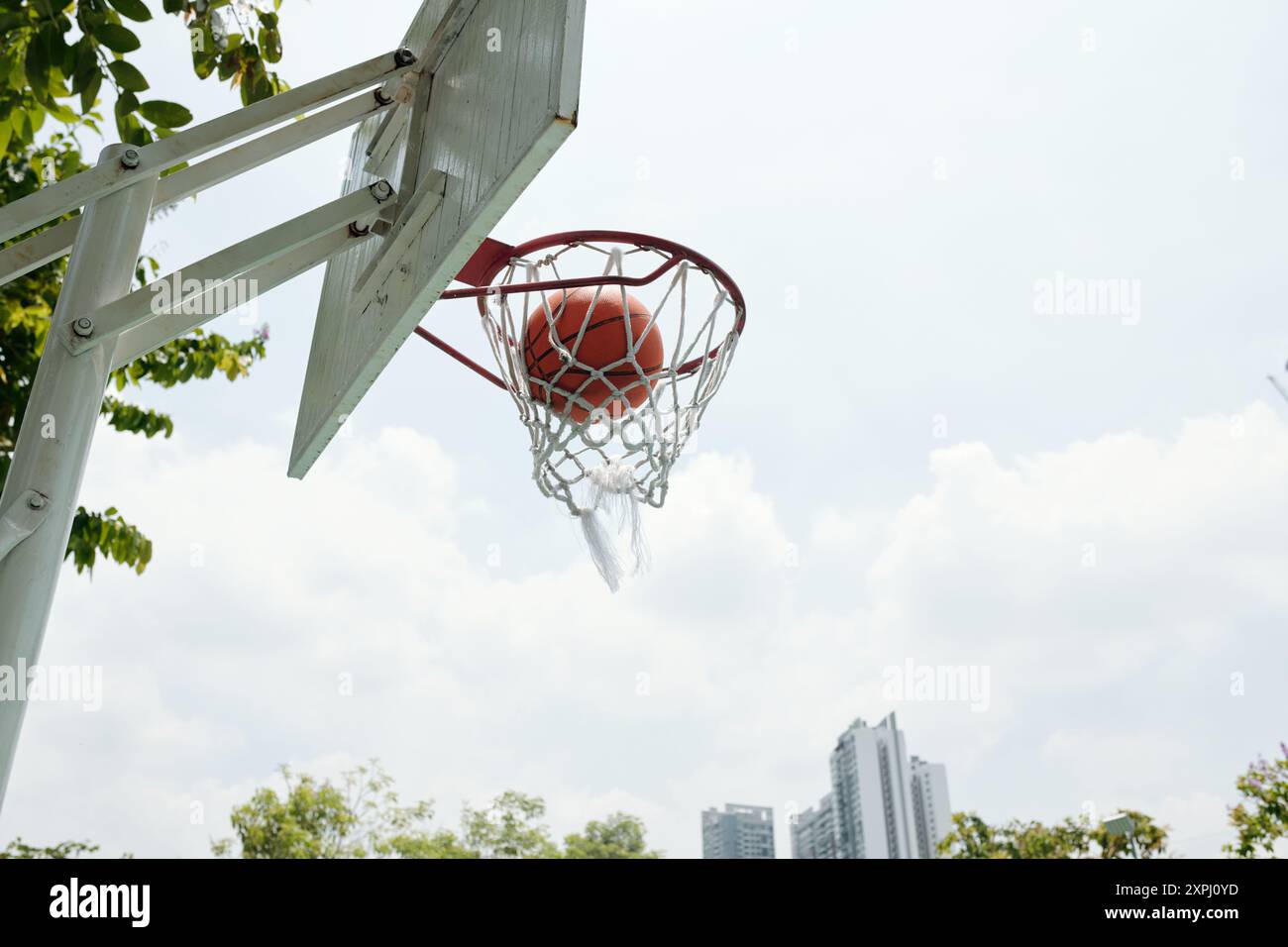 Basketball Going Through Urban Basketball Hoop Outside Stock Photo - Alamy