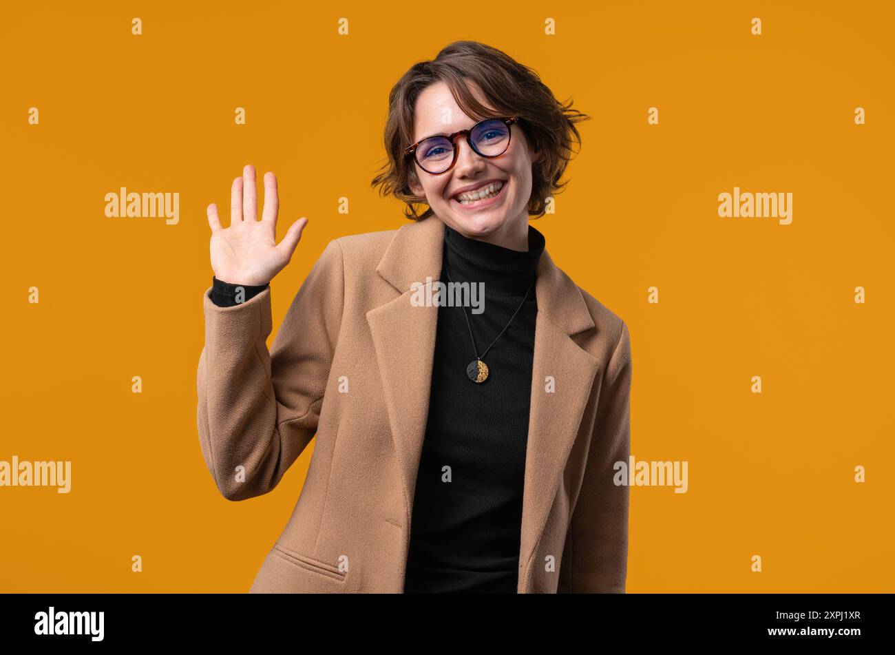 Friendly smiling girl waving hand hi-res stock photography and images ...