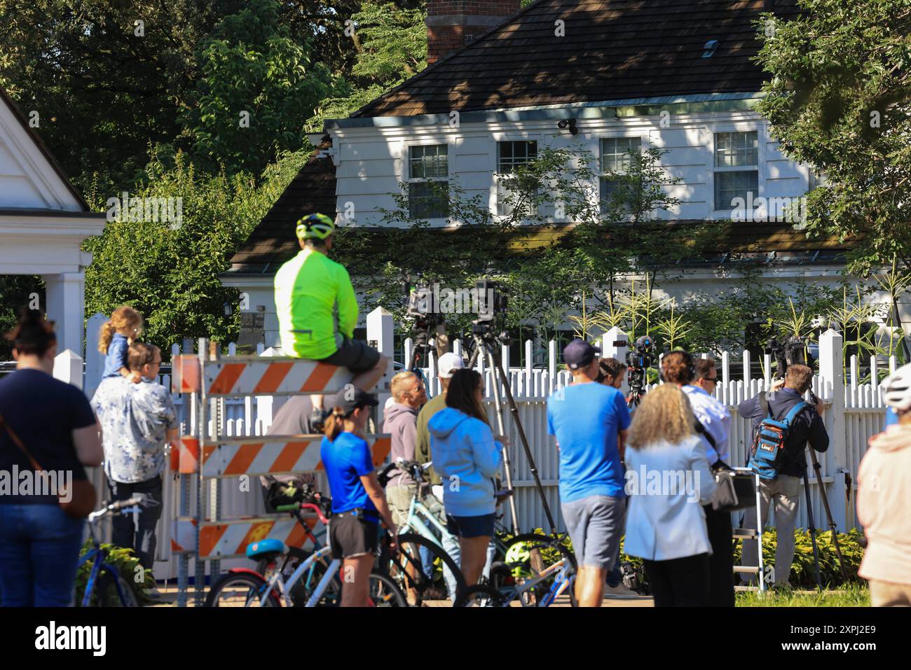 Cameras and crowds gather outside the residence of Minnesota Gov. Tim ...