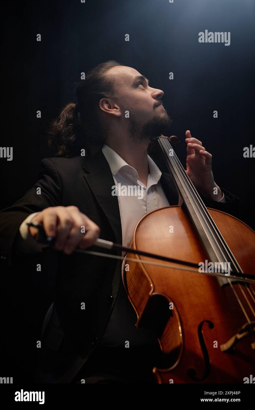 Vertical side view portrait of thoughtful male musician looking up ...