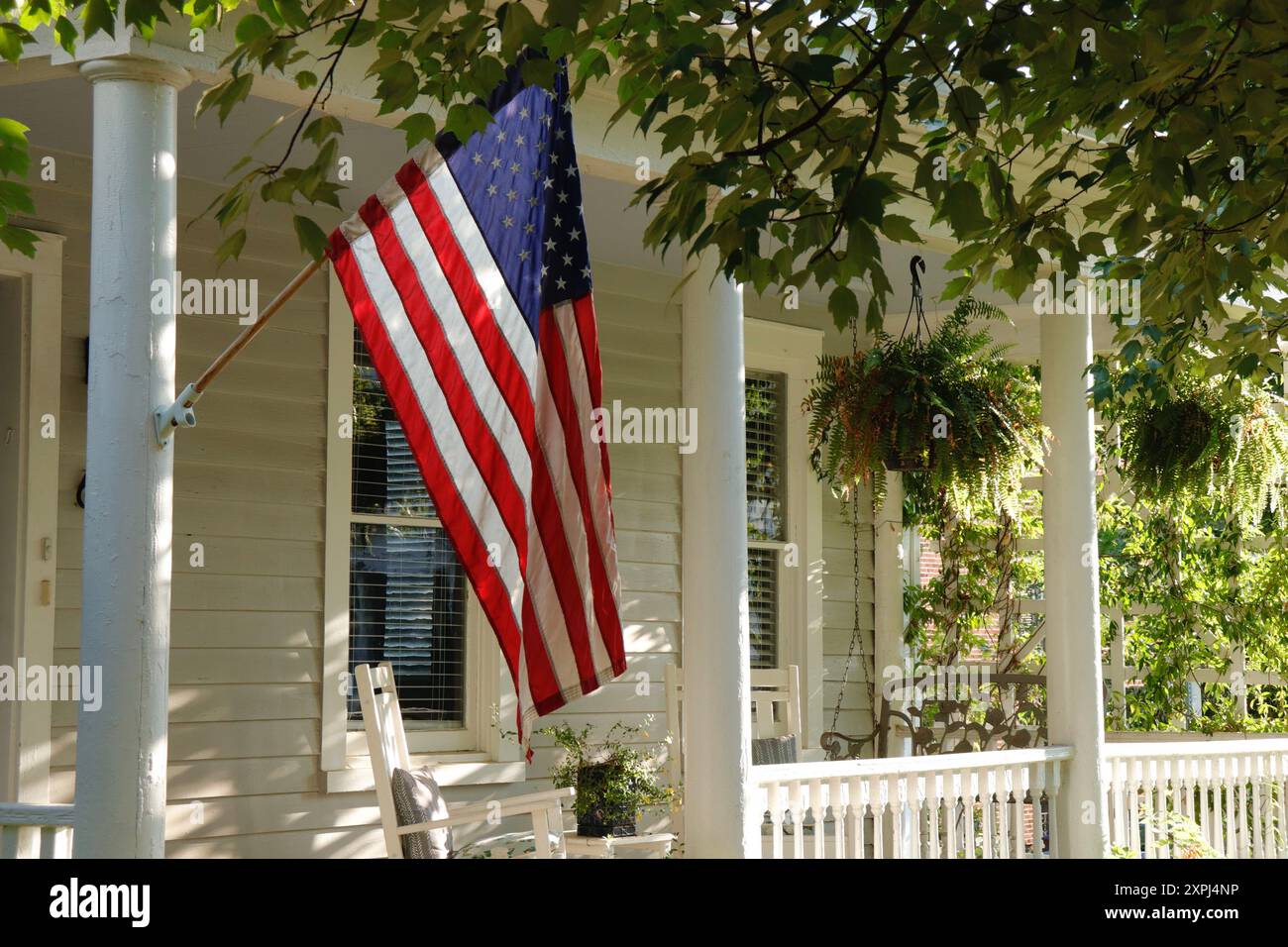 American Flag Hangs on Front Porch Stock Photo - Alamy