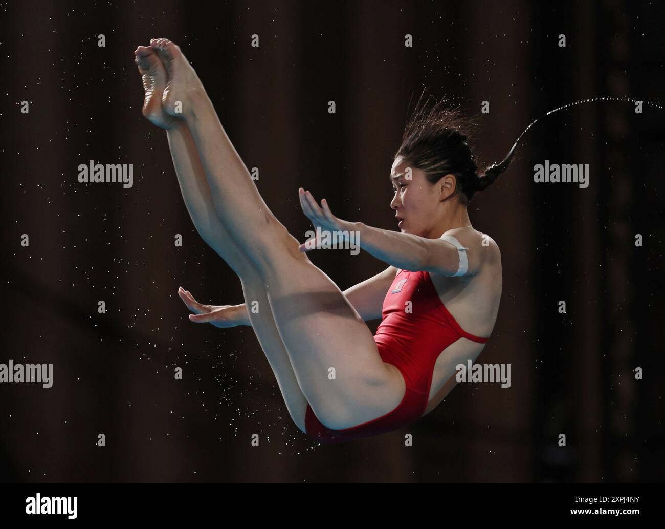 KIM Mi Rae of North Korea performs during the women's diving 10-meter ...