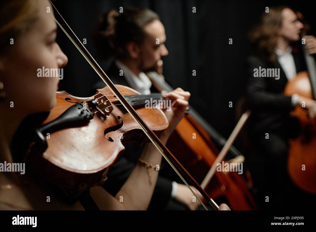 Cropped side view shot of unrecognizable female musician playing violin ...