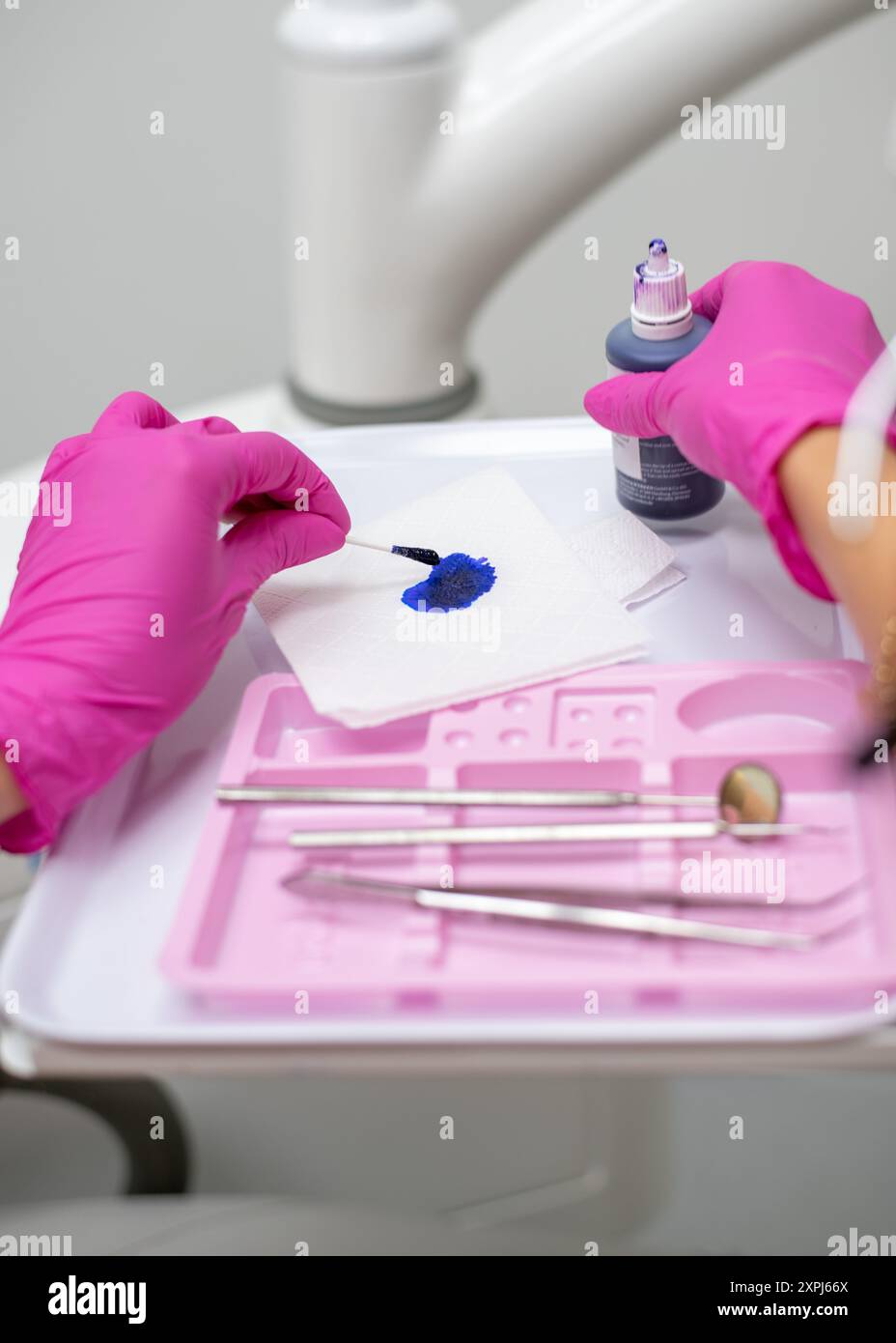 Dentist applying plaque disclosing solution to child's teeth Stock ...