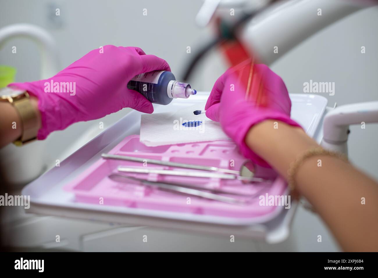 Dentist applying plaque disclosing solution to child's teeth Stock ...