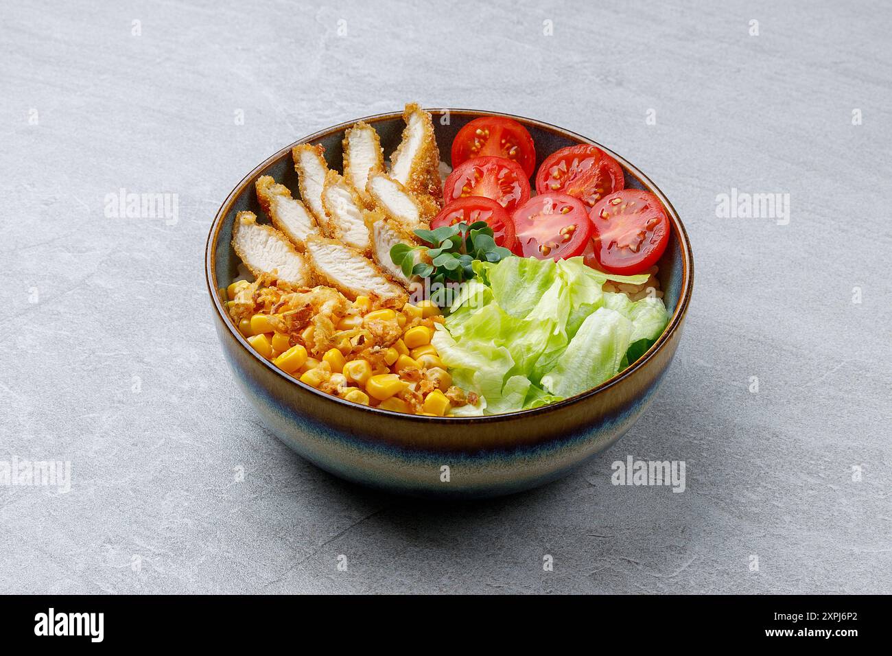 Crispy breaded chicken poke bowl on a gray background for a food ...