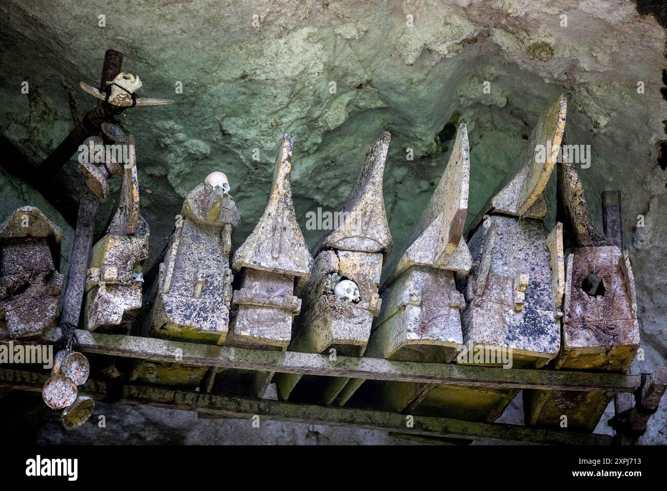 Old coffins with human remains and skuls at the entrance of a cave at ...