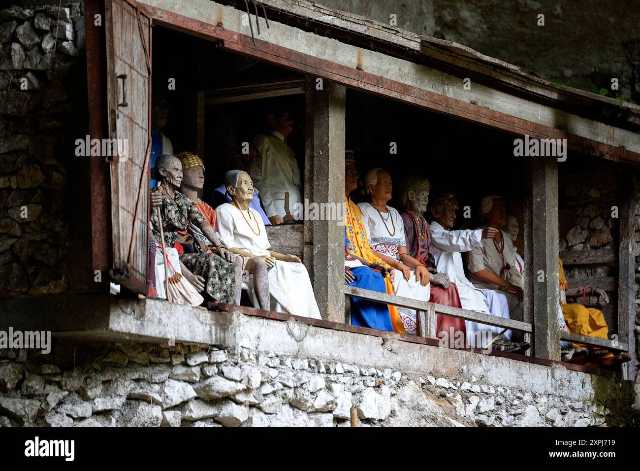 Tau-tau, a carved wooden effigy resembling the dead body buried there ...