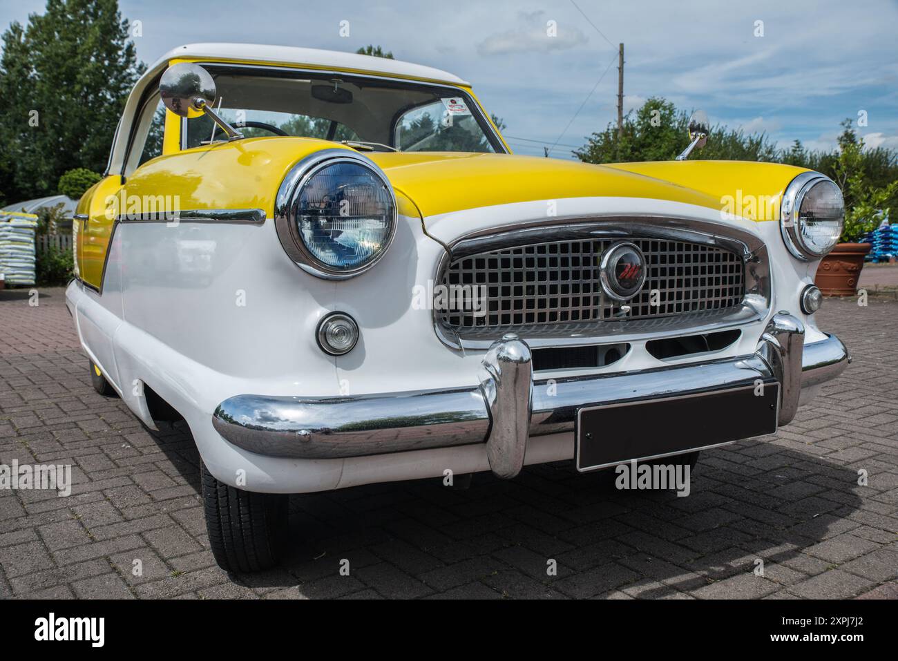 A front end view of a 1957 Metropolitan in yellow and white, also marketed as a Nash ...