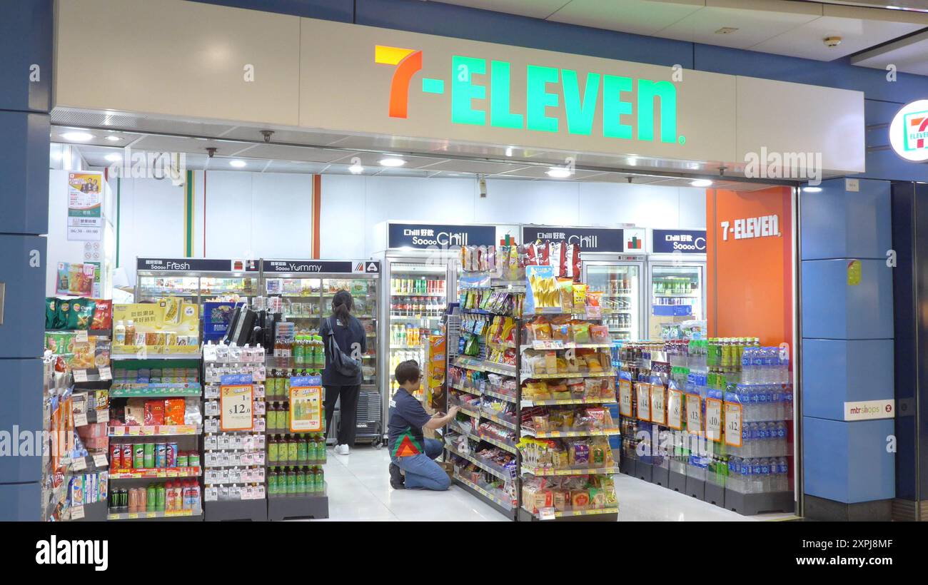 Customers buy drinks inside the American convenience chain 7-Eleven store chain in Hong Kong ...