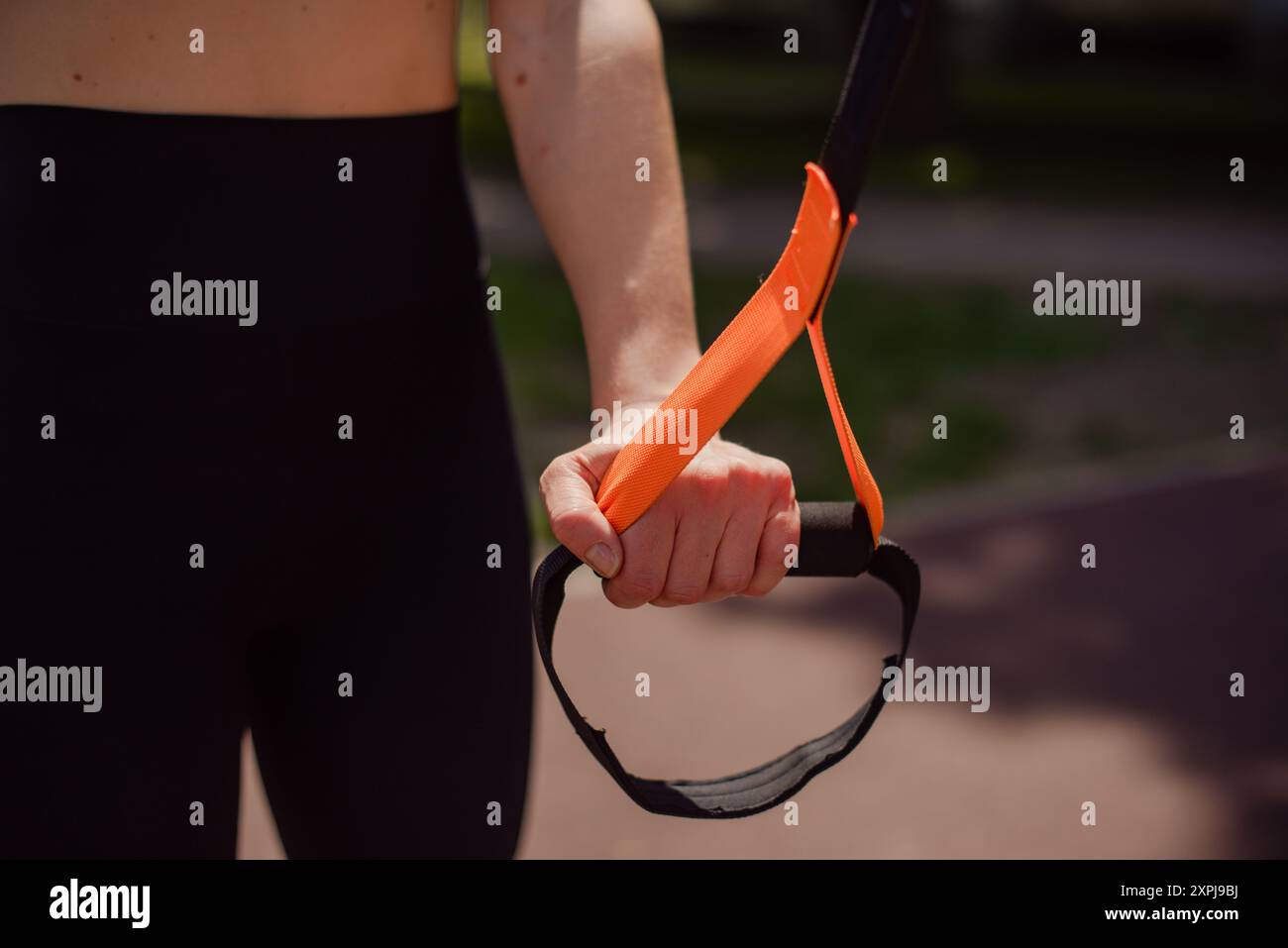 closeup woman hand holding trx loop ready to training outdoors Stock ...