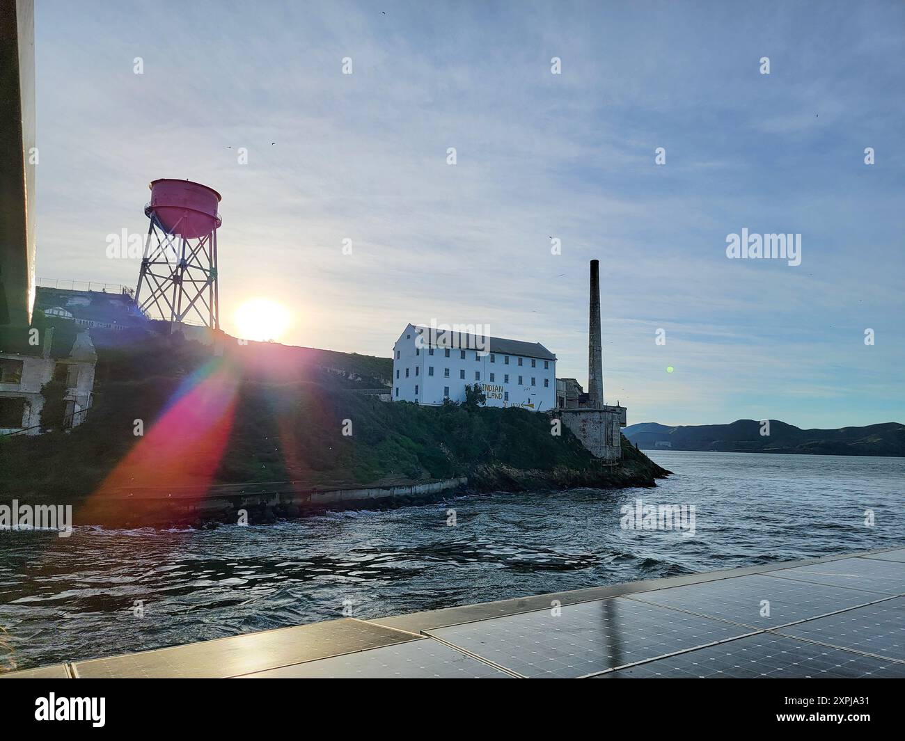 A sunset view of Alcatraz Island with water tower and building, San ...