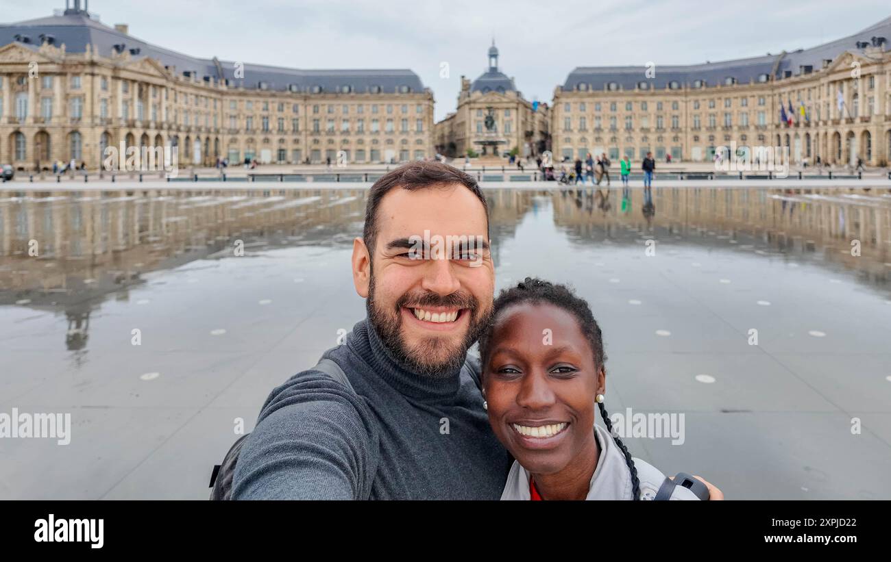 multicultural couple taking a selfie while smiling in Bordeaux Stock ...